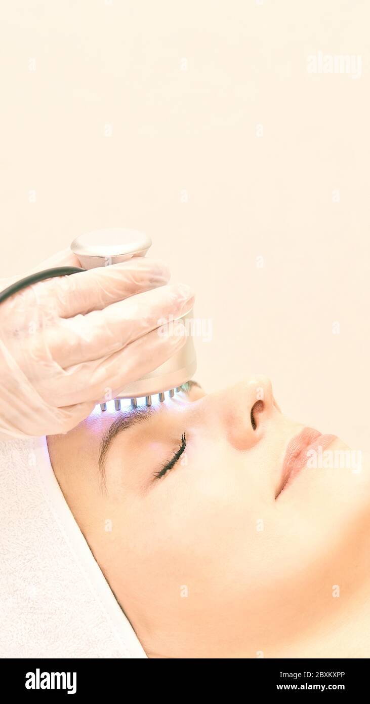 Light infrared therapy. Cosmetology head procedure. Beauty woman face ...