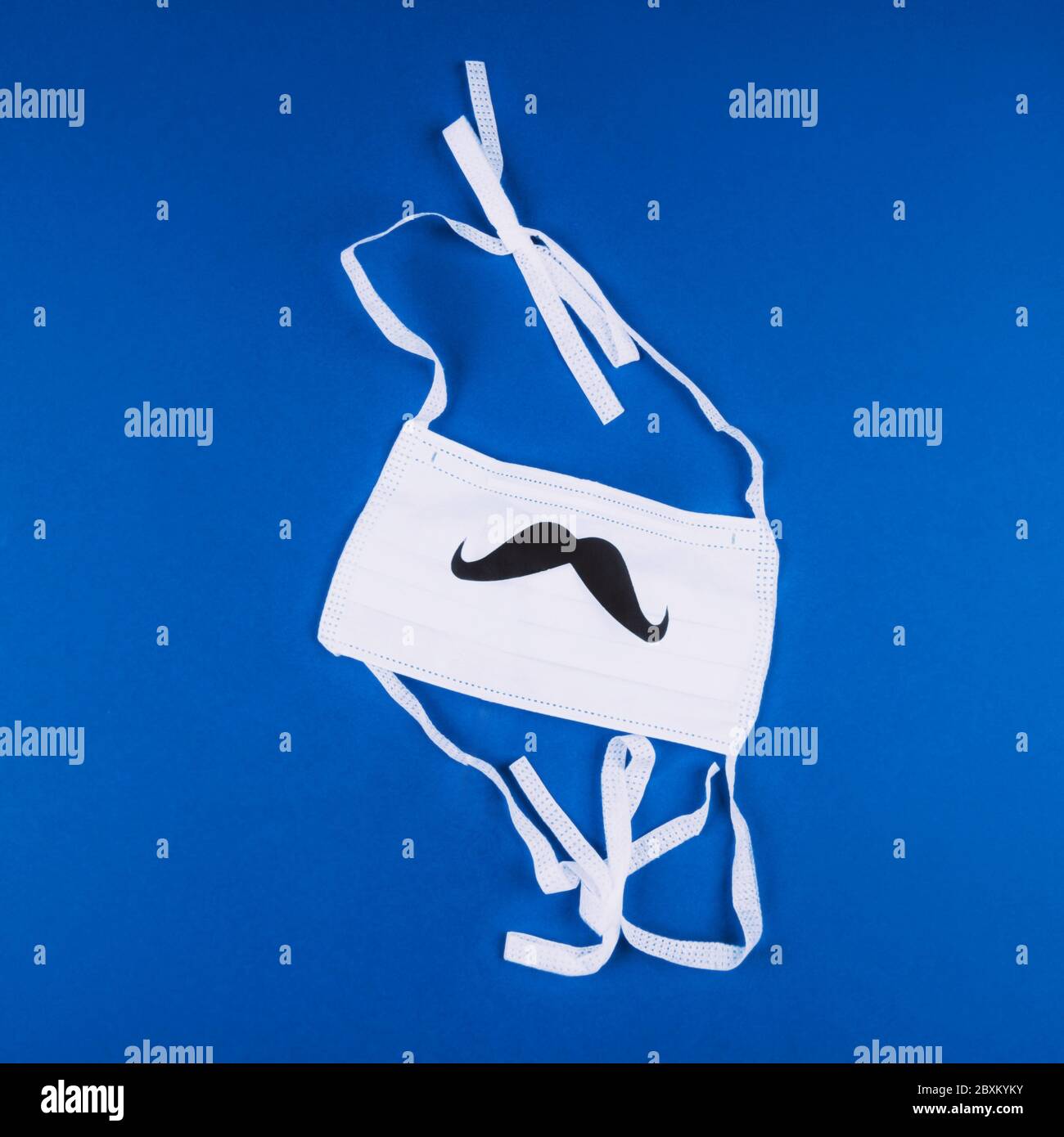 Medical mask with a man's mustache on a blue background Stock Photo - Alamy