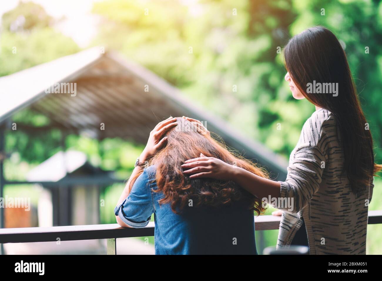 Sad girl crying friend comforting hi-res stock photography and images ...
