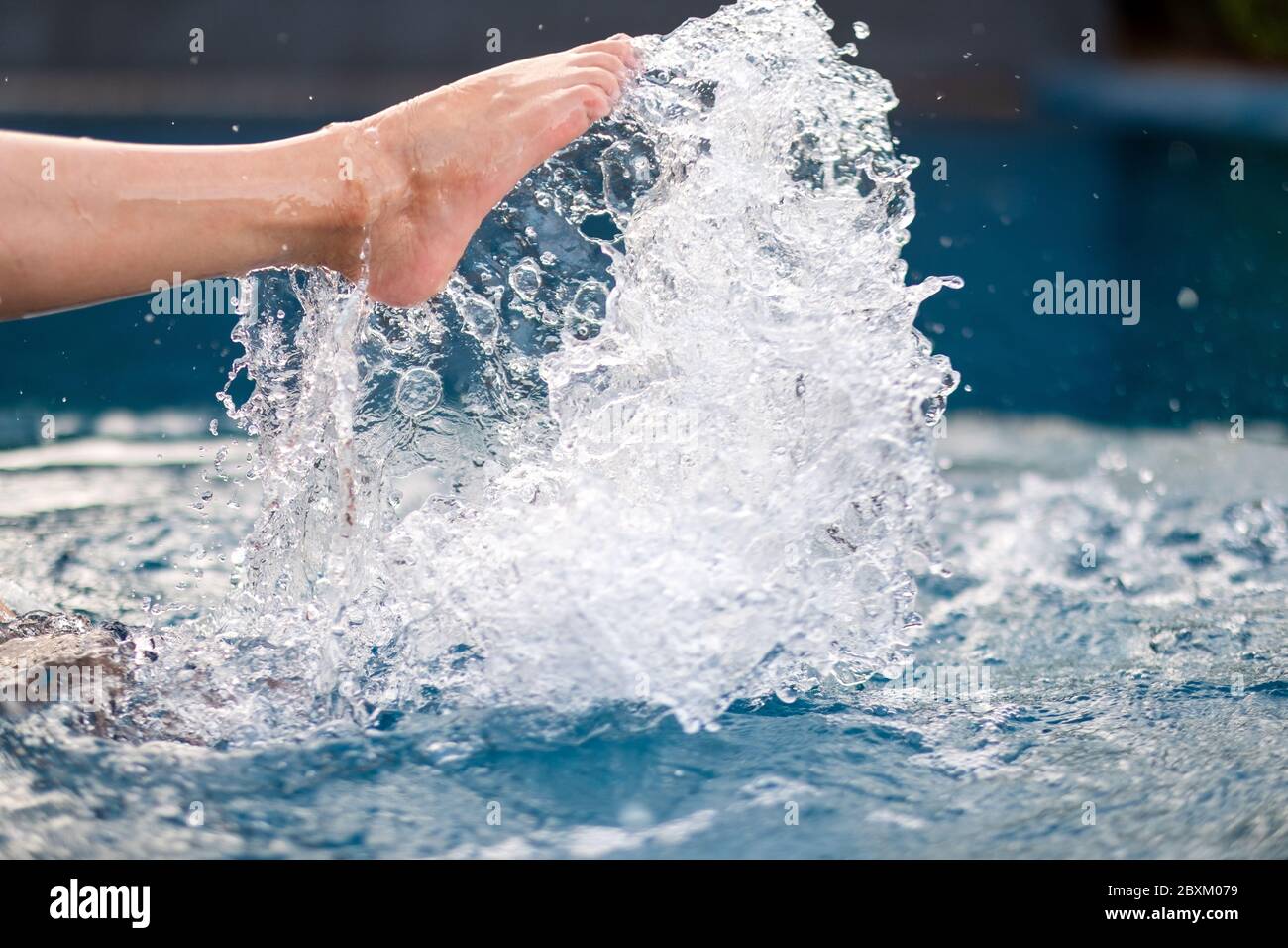 Woman dipping feet in pool hi-res stock photography and images - Alamy