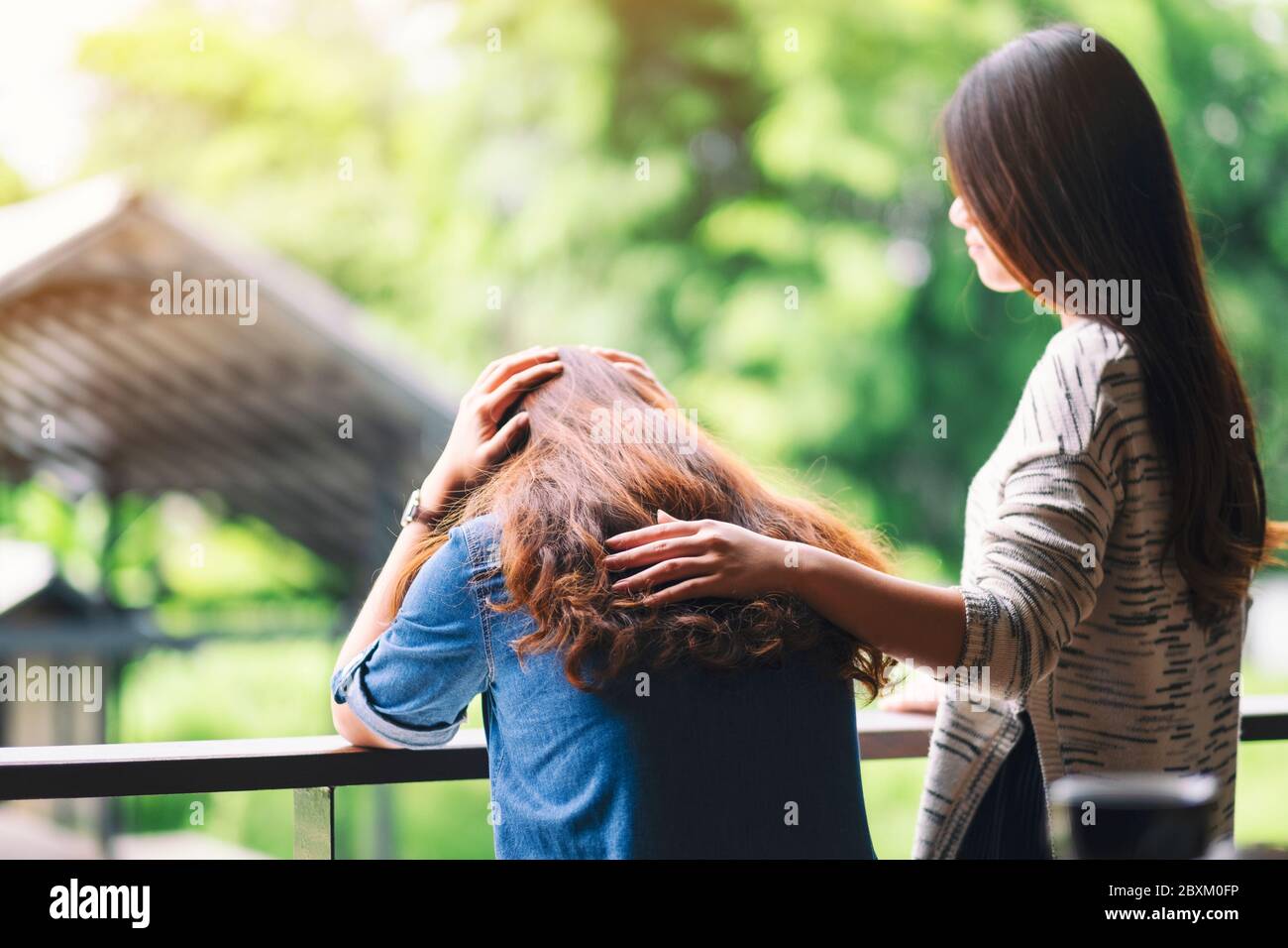 Sad girl crying friend comforting hi-res stock photography and images ...