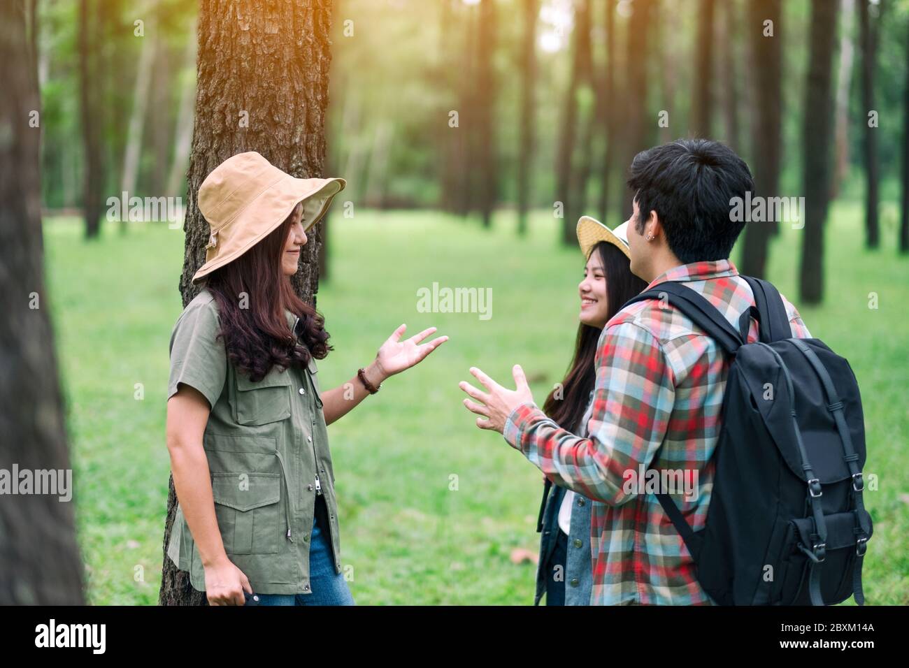 A group of travelers talking to each other while hiking in a beautiful ...