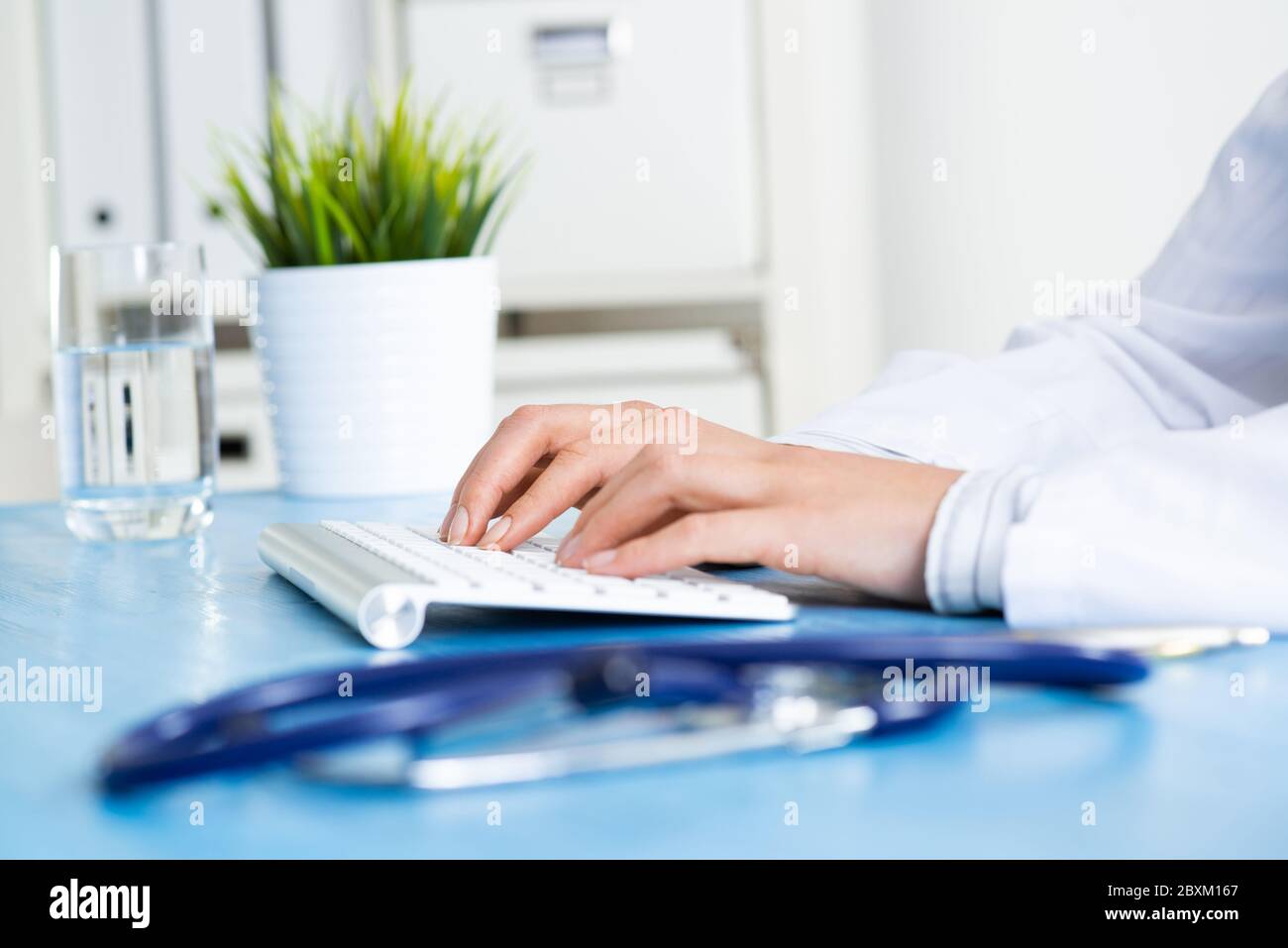Doctor typing at computer keyboard Stock Photo - Alamy