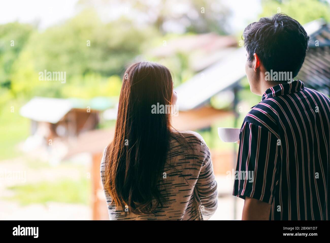 Asian couple greeting friends hi-res stock photography and images - Alamy