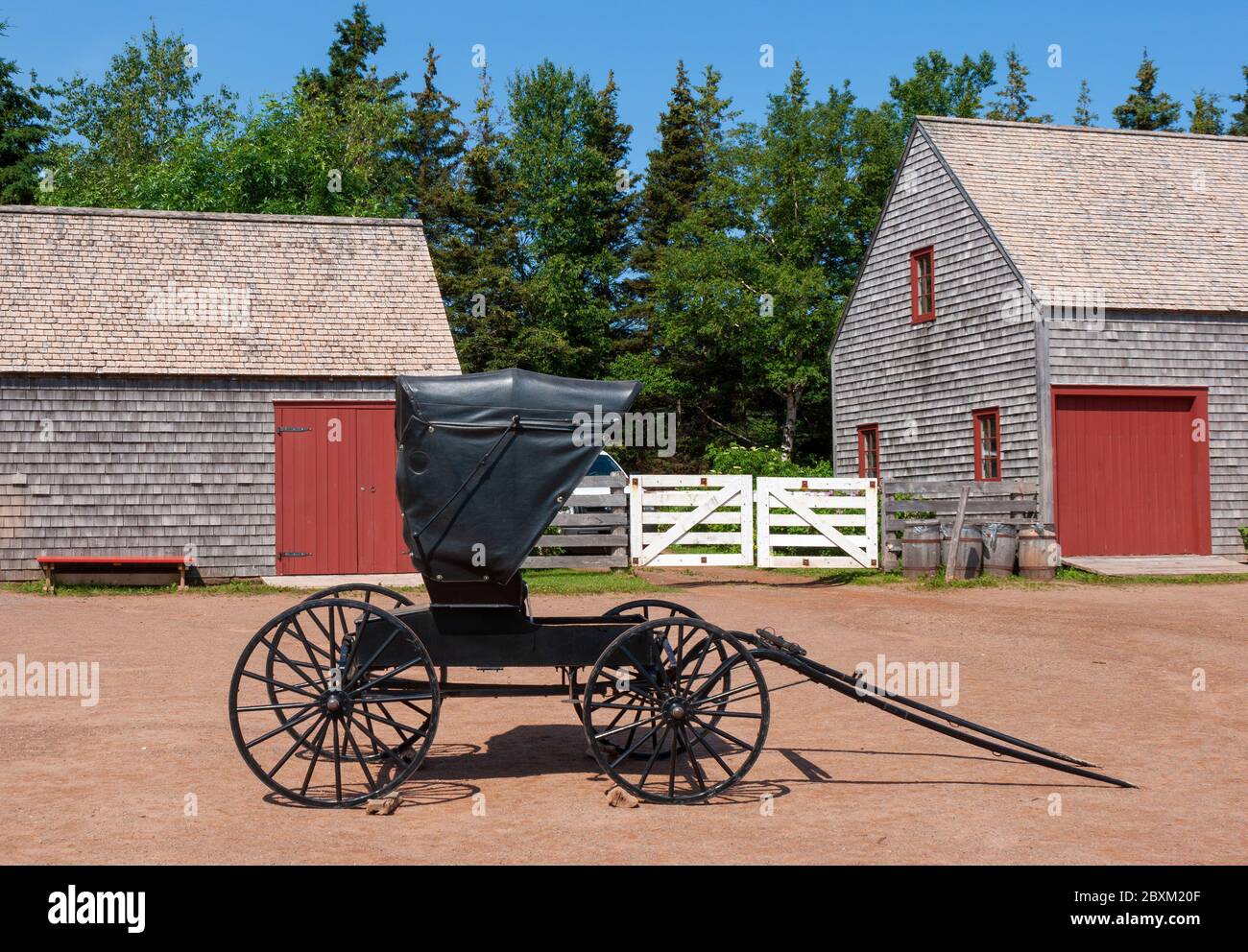 Buggy in a farmyard. Outbuildings in a traditional homestead. Green ...