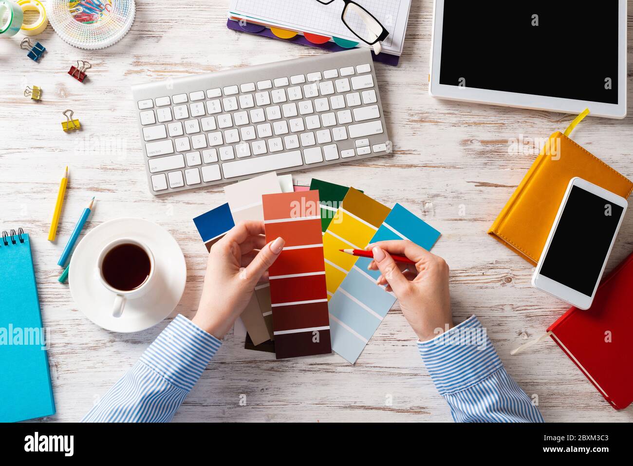 Interior designer choosing colors from swatches Stock Photo - Alamy