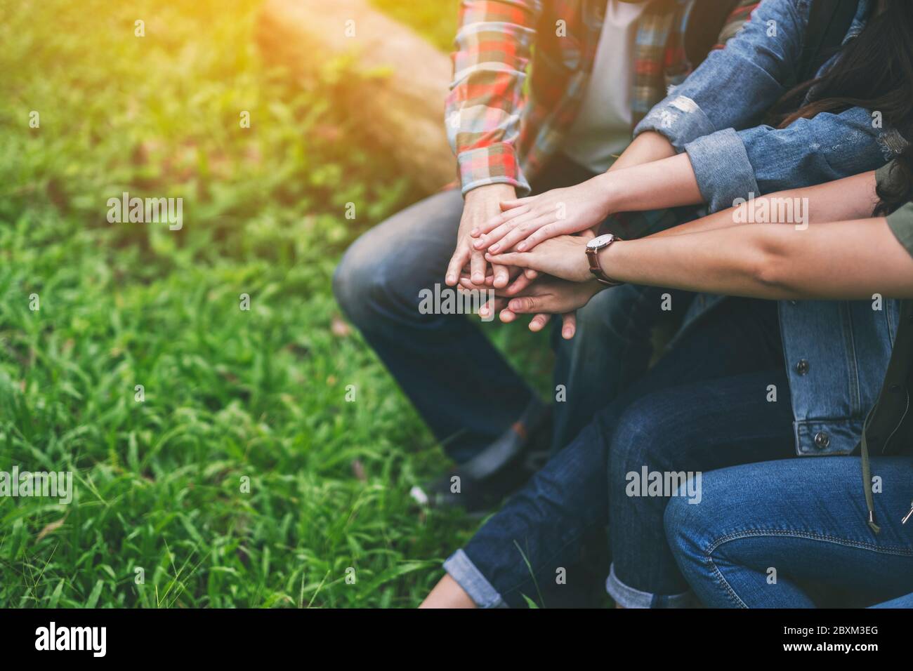 Closeup image of people putting their hands together in the outdoors ...