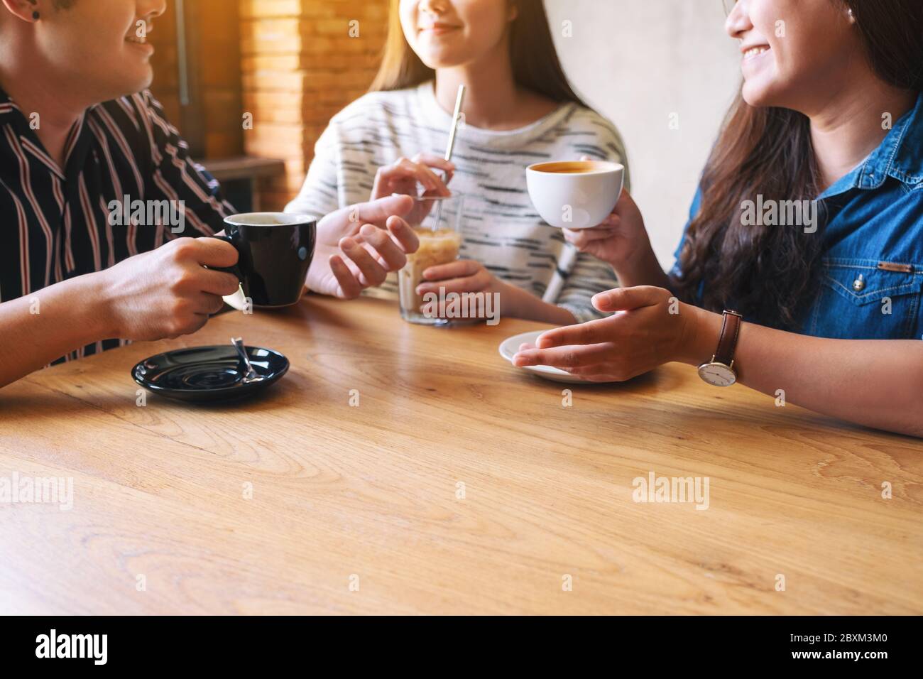 Closeup image of three people enjoyed talking and drinking coffee ...