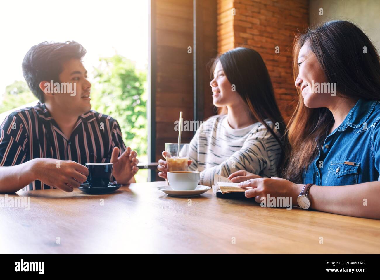 Closeup image of three people enjoyed talking and drinking coffee ...