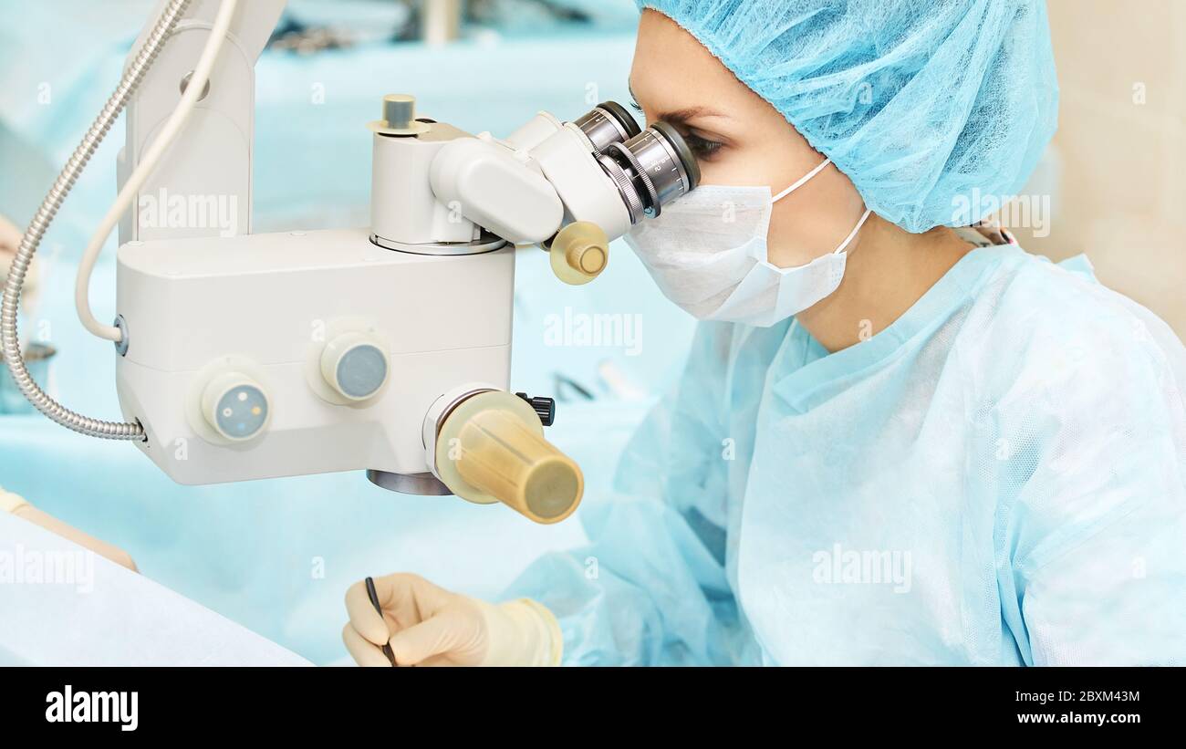 Ophthalmology laser microscope operation. Doctor in clinic. Patient eye ...