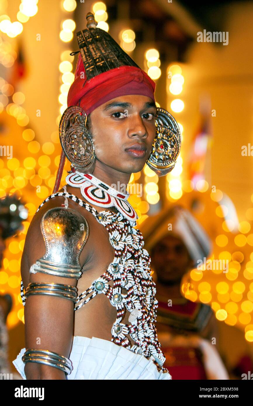 An Up Country Dancer waits to perform during the Esala Perahera at ...