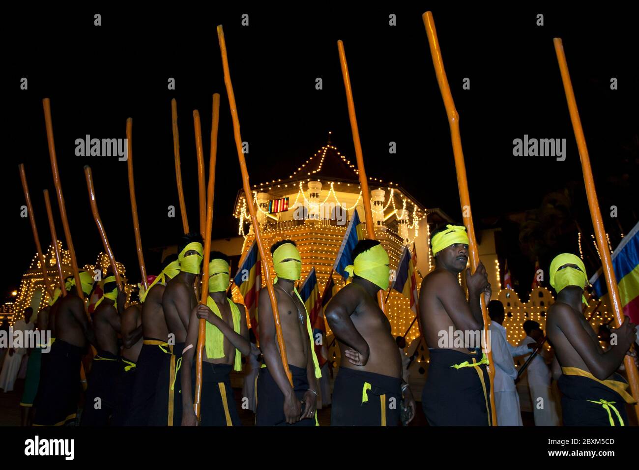 Torch bearers wait for the start of the Esala Perahera at Kandy in Sri ...
