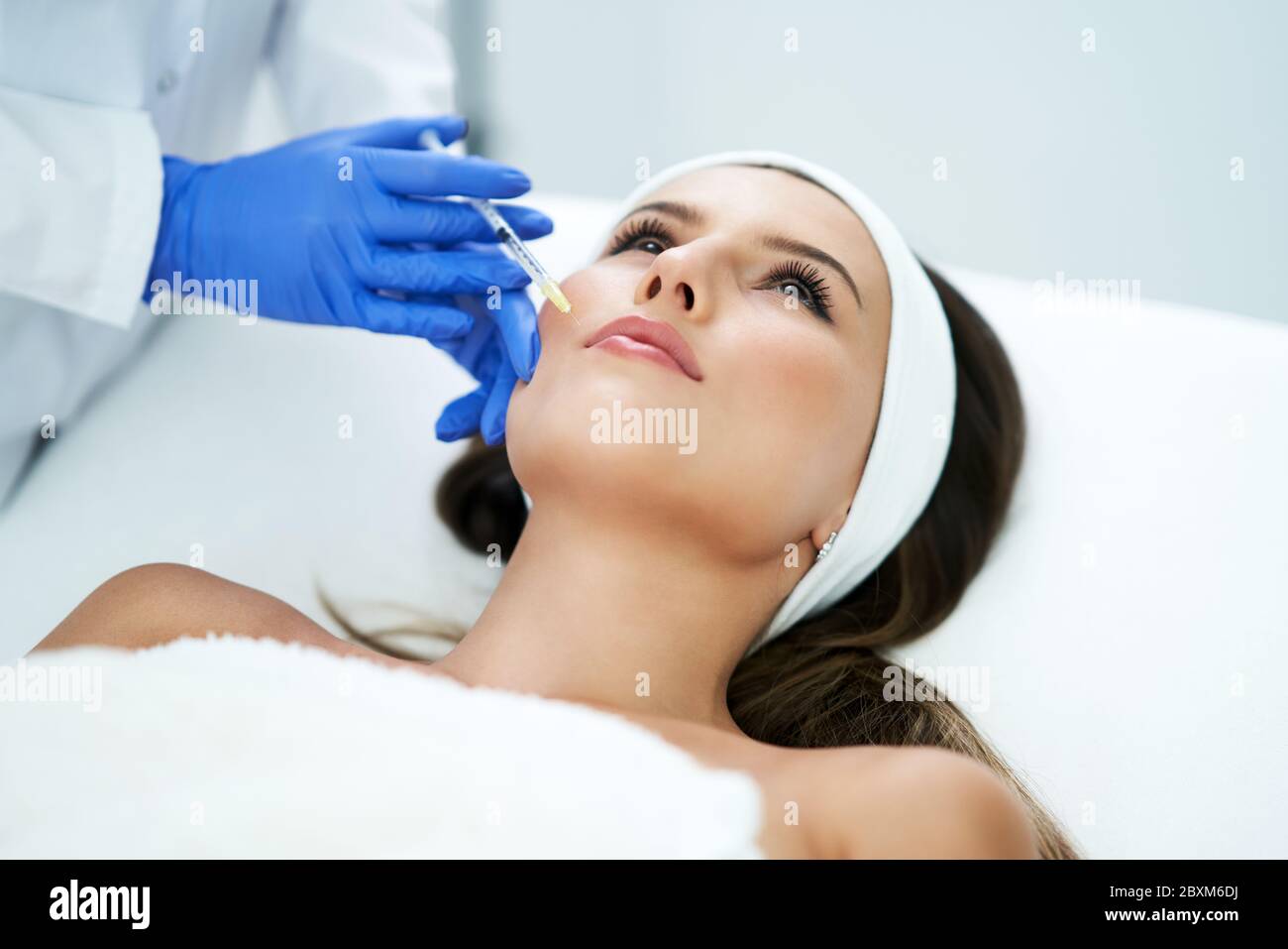 Beautiful young woman getting acid face treatment at beauty salon Stock ...