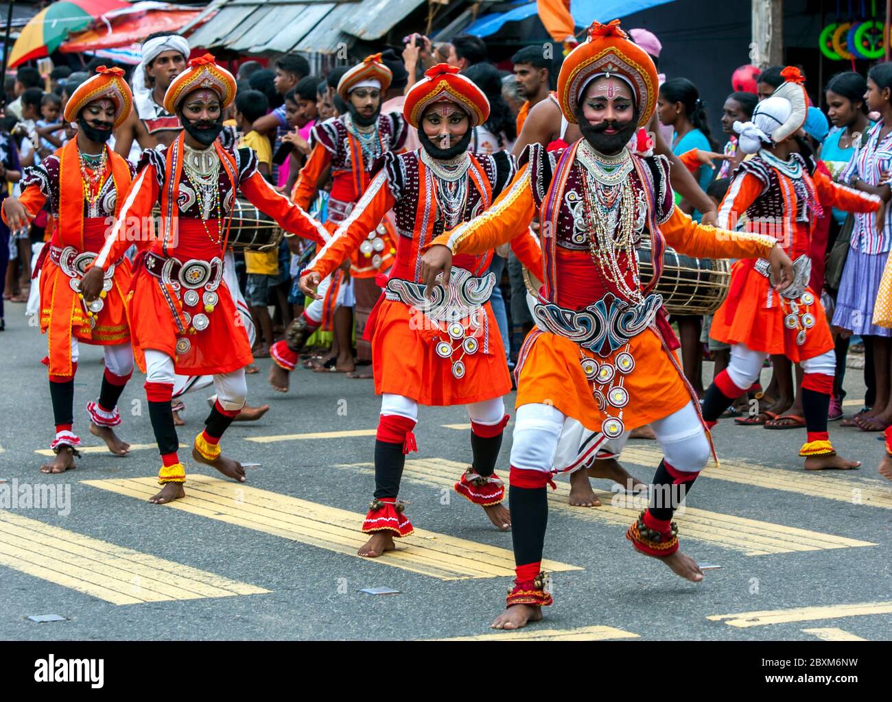 Colourfully dressed dancers perform during the Hikkaduwa Perahera in ...