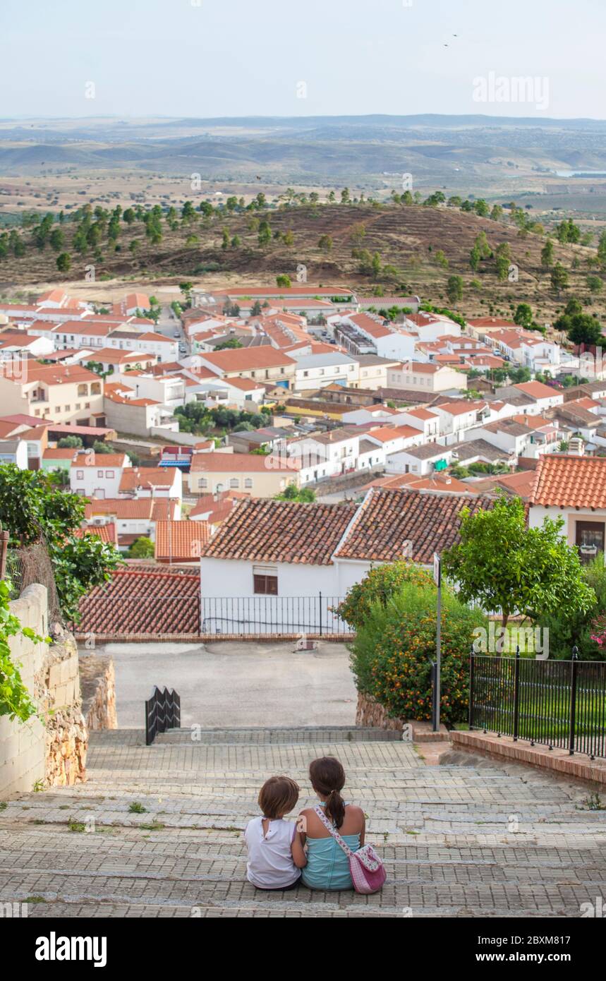 Children sitting on stairs of steep street in Hornachos, Spain. Rural ...