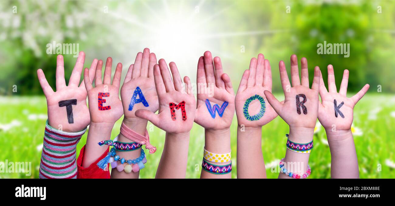 Children Hands Building Word Teamwork, Grass Meadow Stock Photo - Alamy