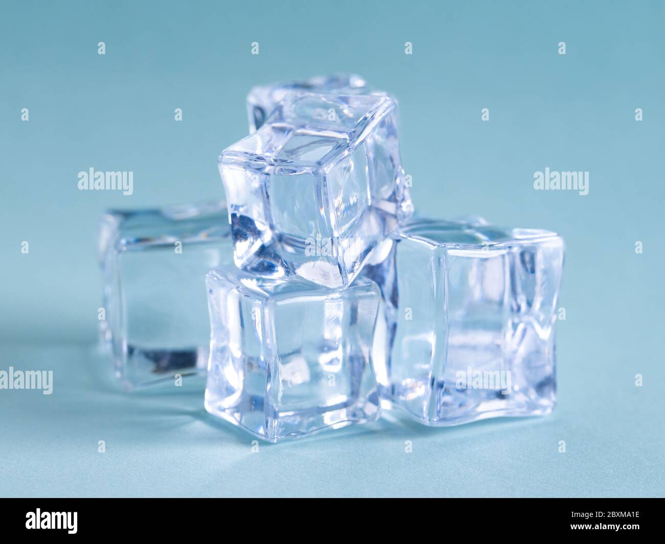 Pile of plastic ice cubes isolated on blue background Stock Photo - Alamy