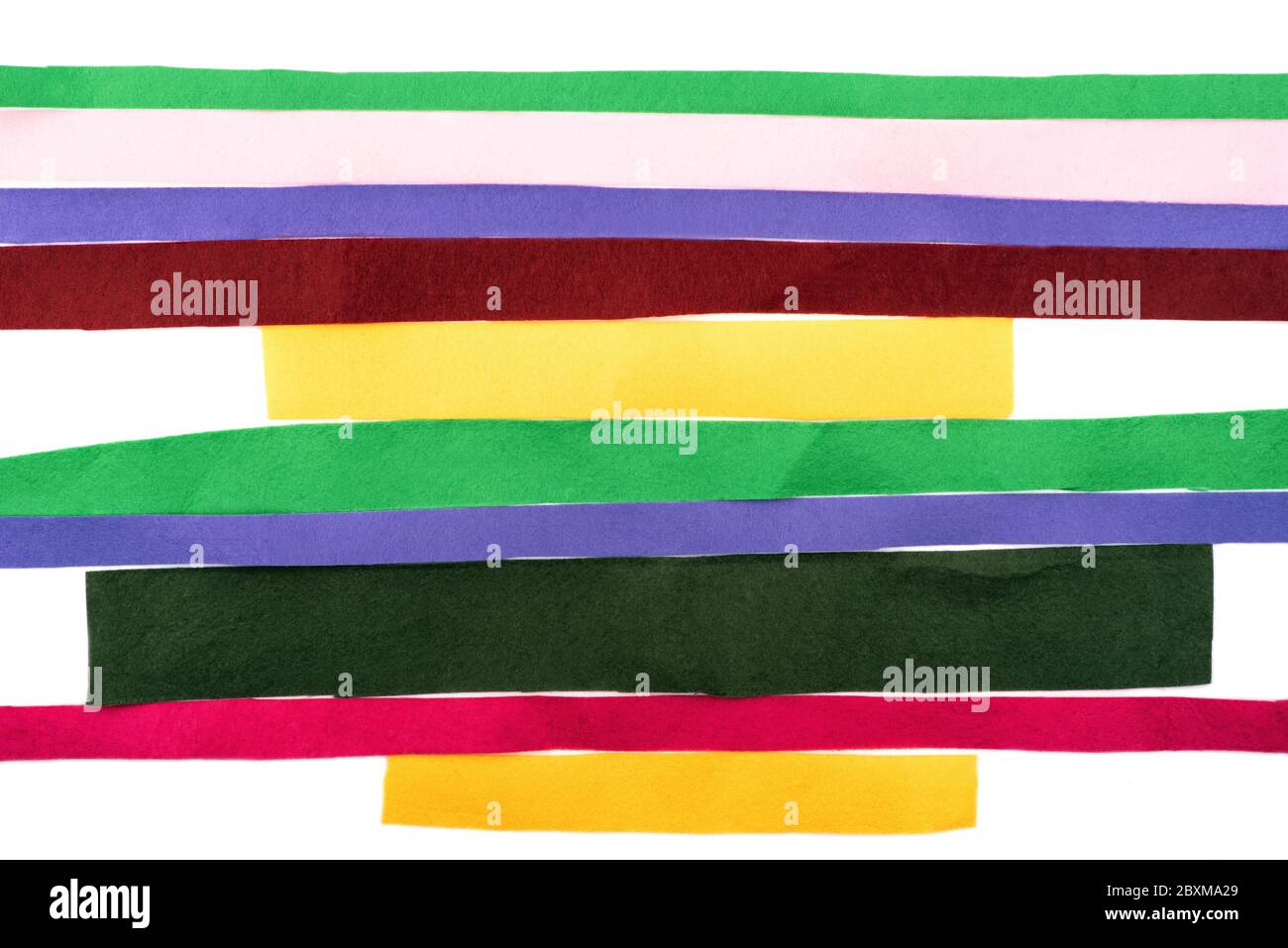 Multi-colored strips of felt fabric horizontally on a white background ...