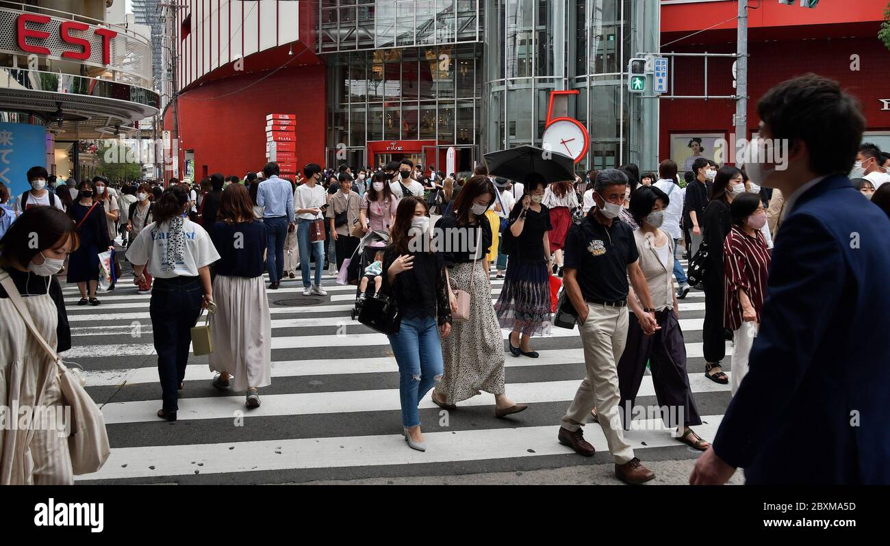 Pedestrians wearing face masks walk near the shopping mall HEP Five at ...
