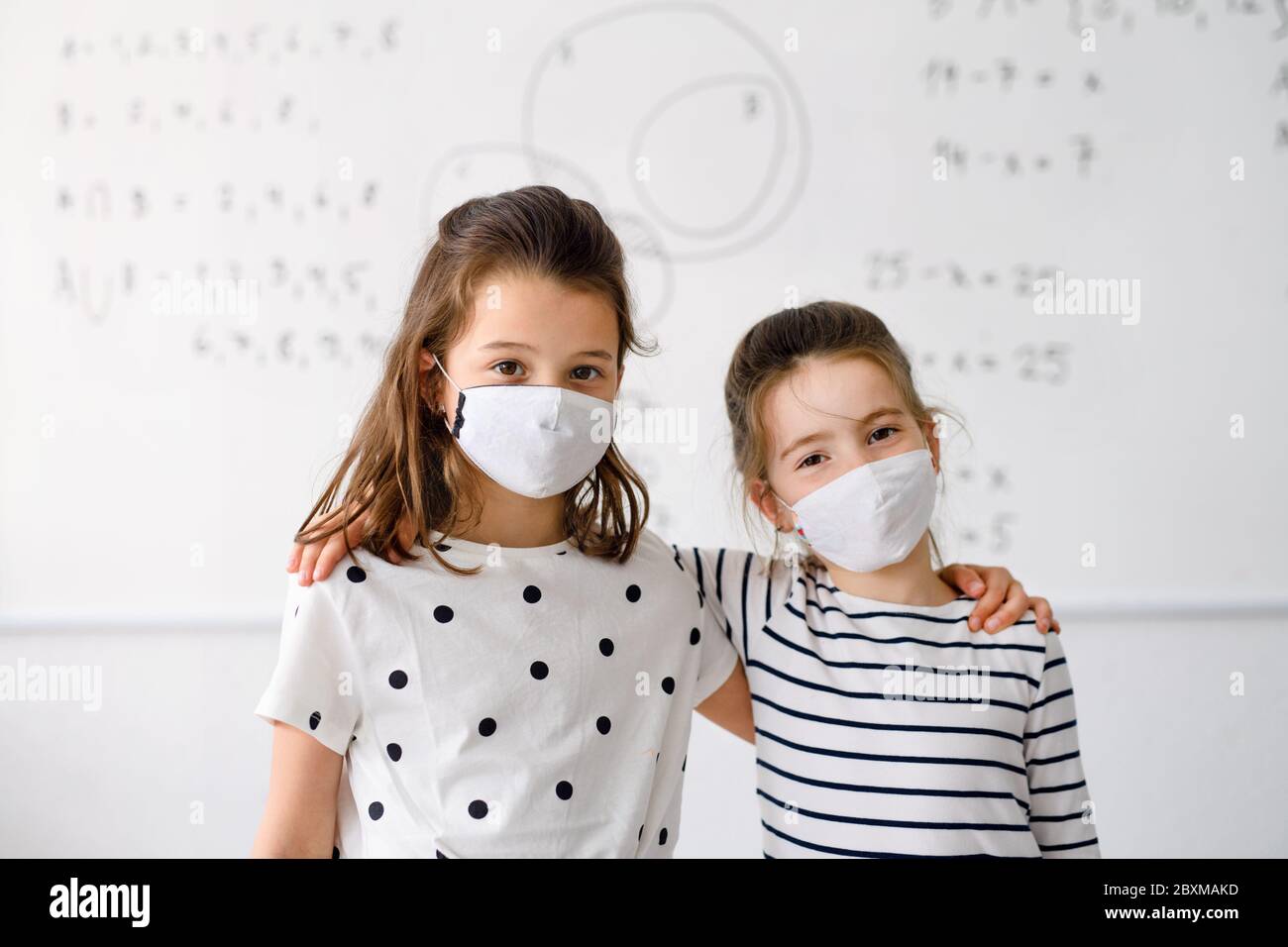 Girls with face mask back at school after covid-19 quarantine and ...