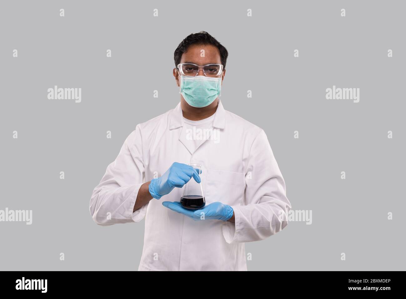 Male Doctor Holding Flask with Colorfull Liquid Wearing Medical Mask ...