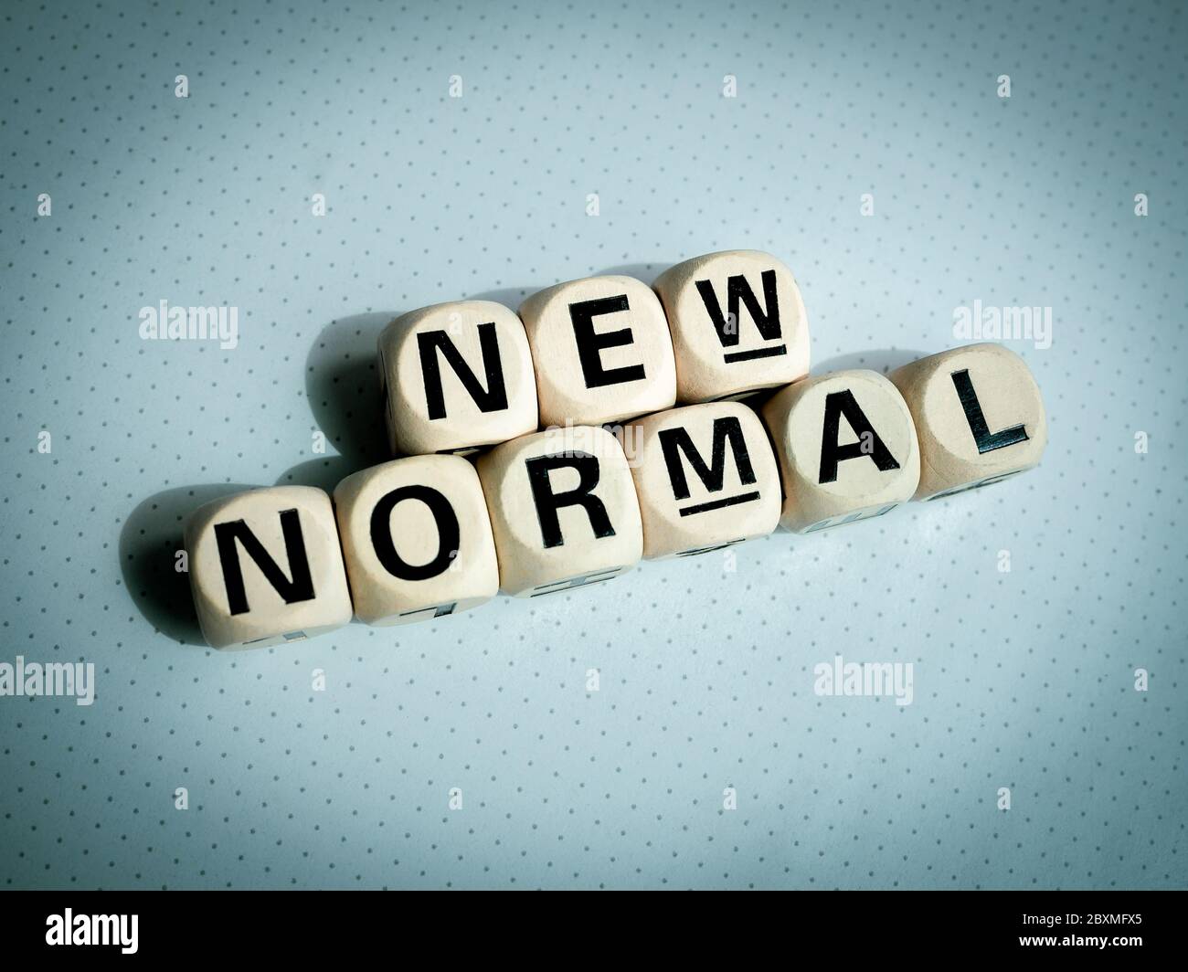 Close-up New Normal, words on wooden alphabet cube on dark background ...