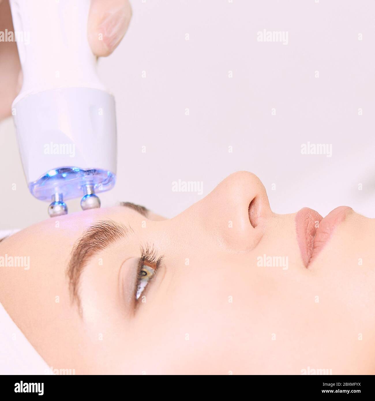 Microcurrent light esthetics procedure. Beauty girl face. Cosmetology ...