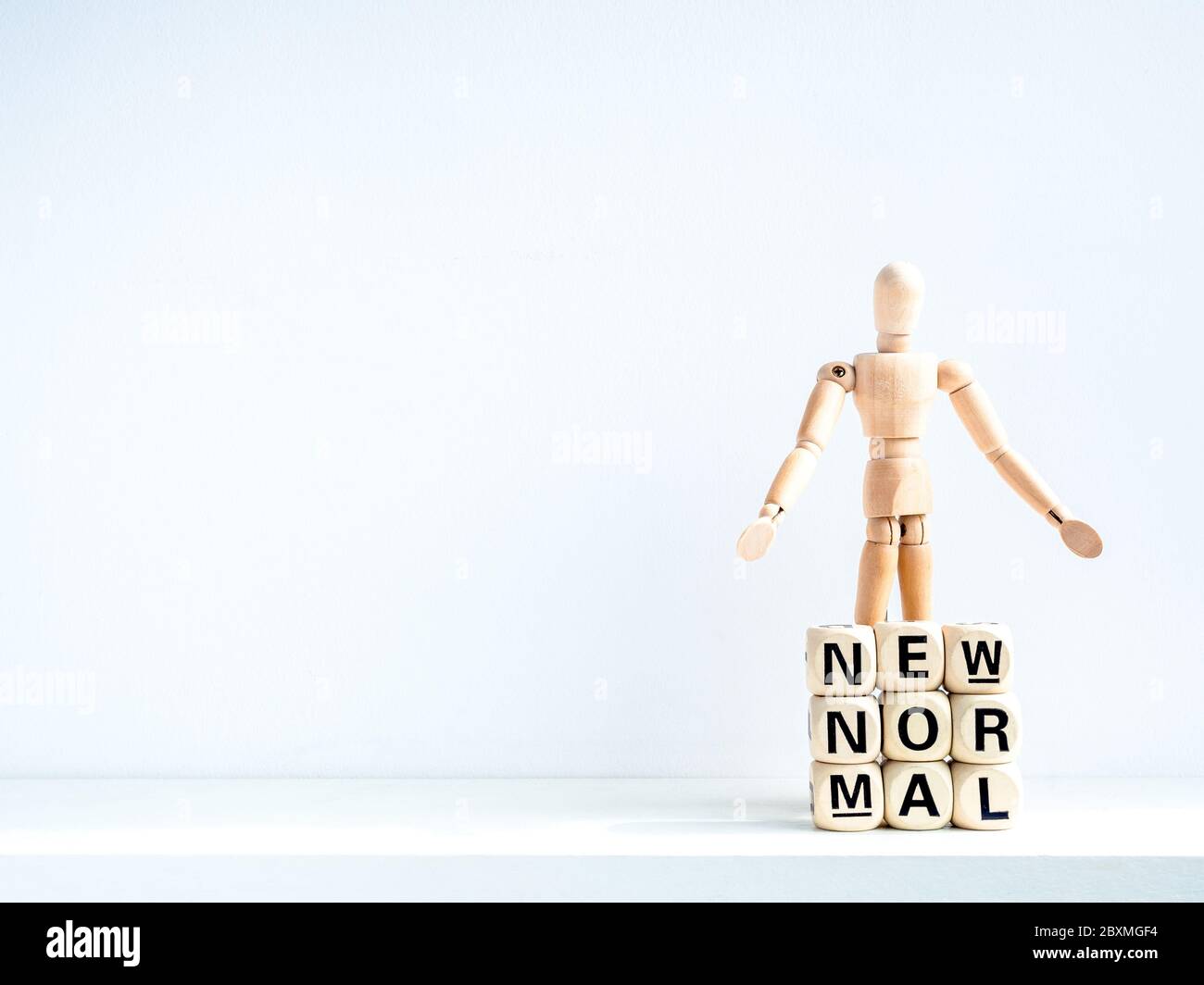 New Normal, words on wooden alphabet cube and wooden figure on white ...