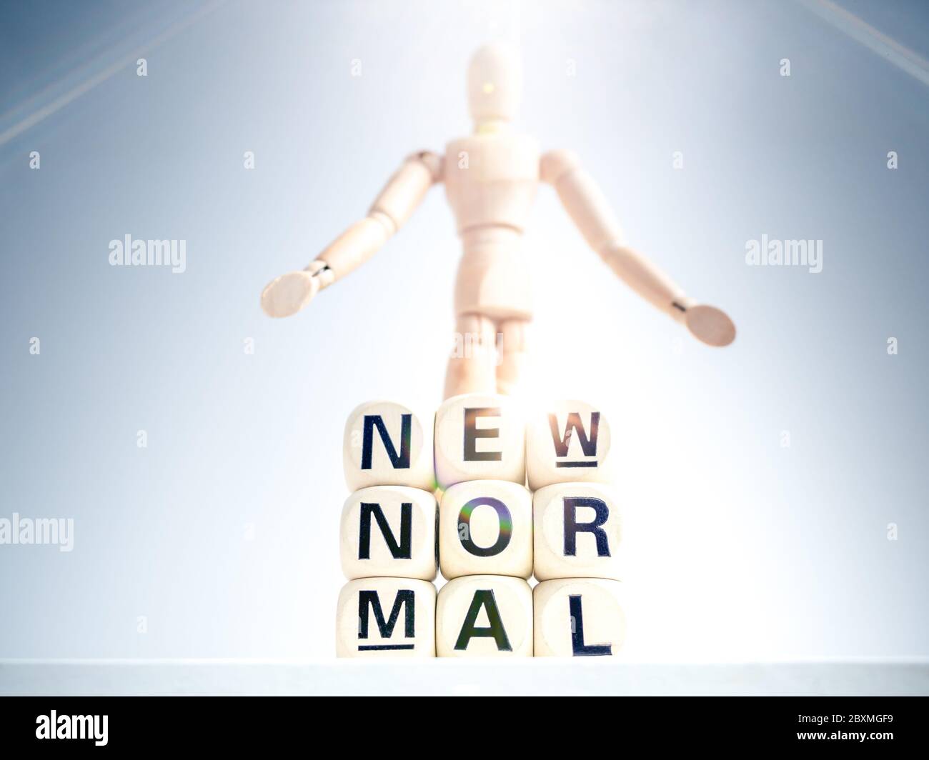 New Normal, words on wooden alphabet cube and wooden figure on white ...