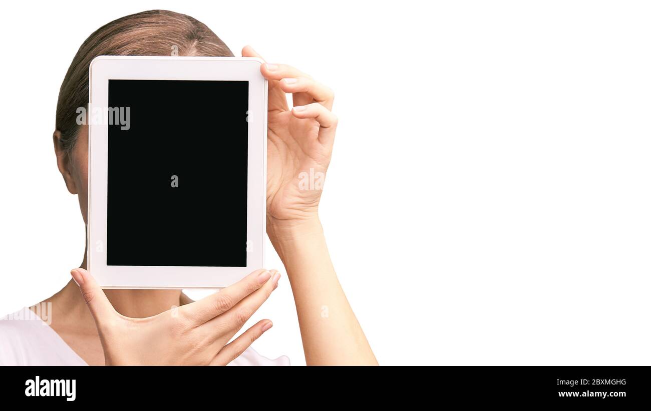 Girl holding computer. Mock up at tablet black screen. Face near laptop ...