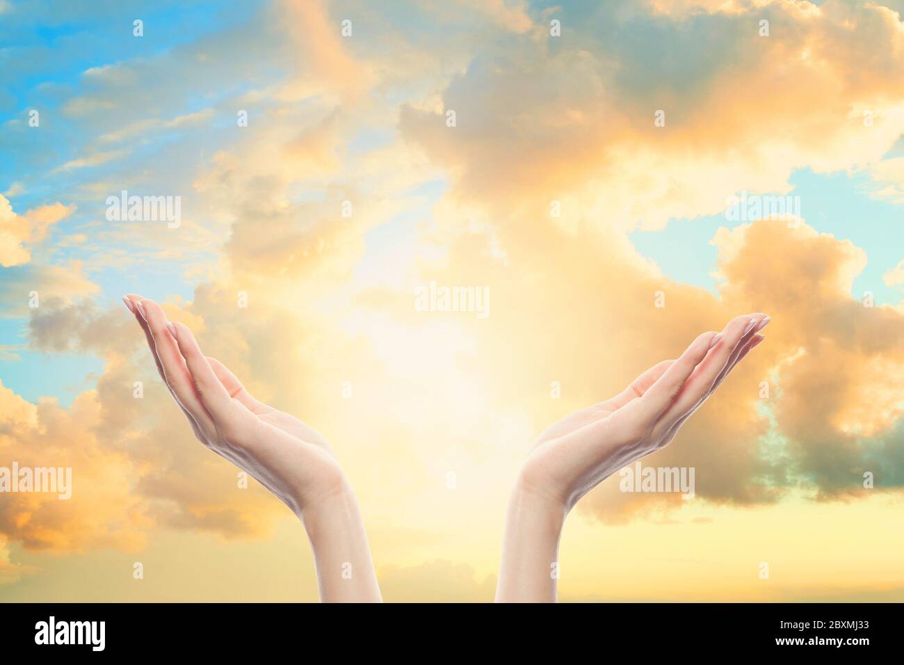 Woman hands reach for the sky clouds in prayer Stock Photo - Alamy
