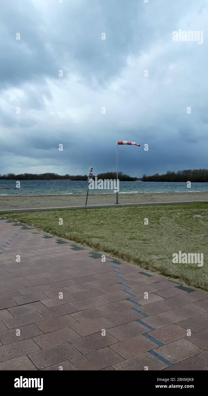 Wind vane is tight ahead with dark clouds over the water of the ...