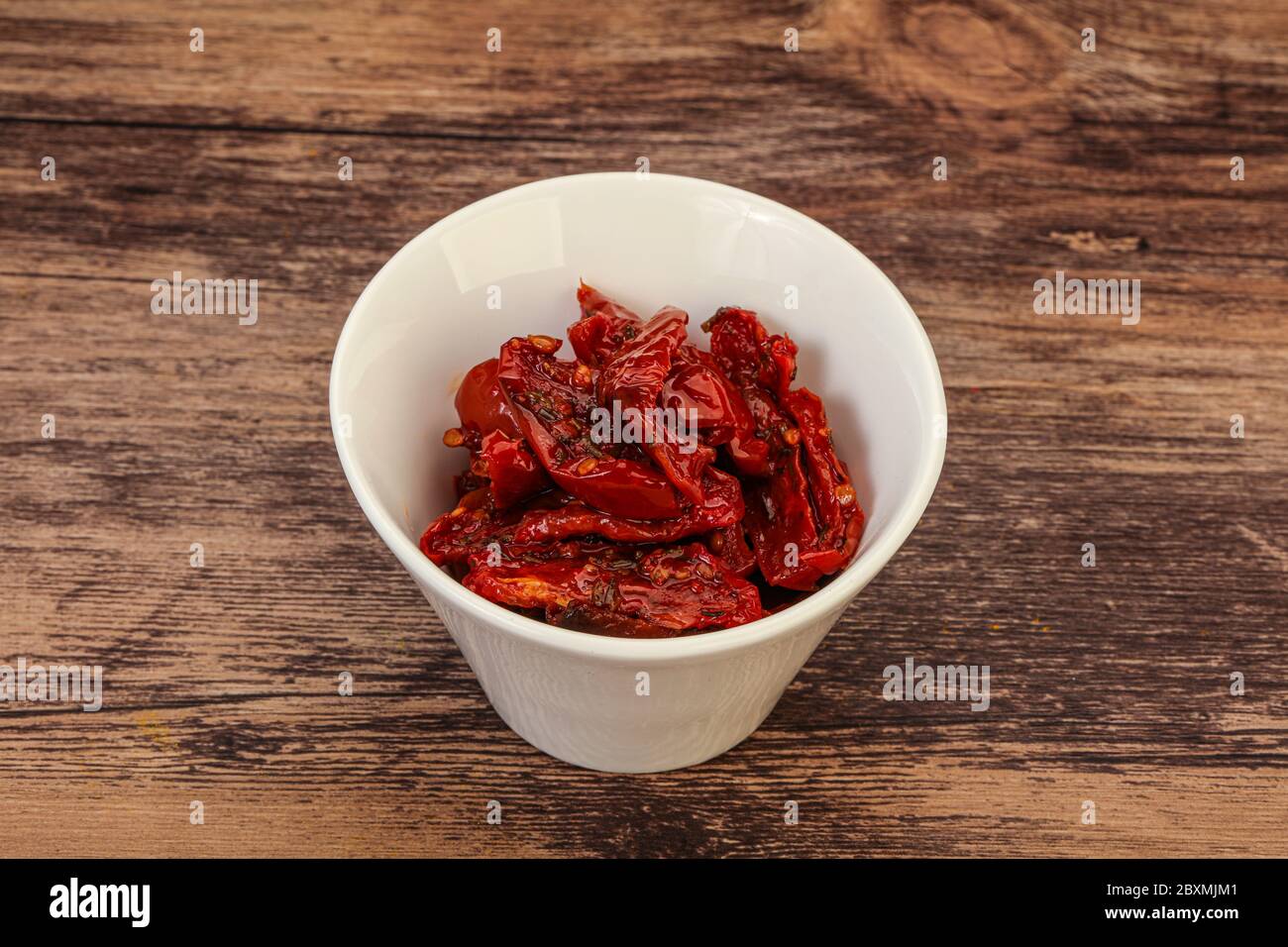 Dried tomato with olive oil and herbs Stock Photo - Alamy