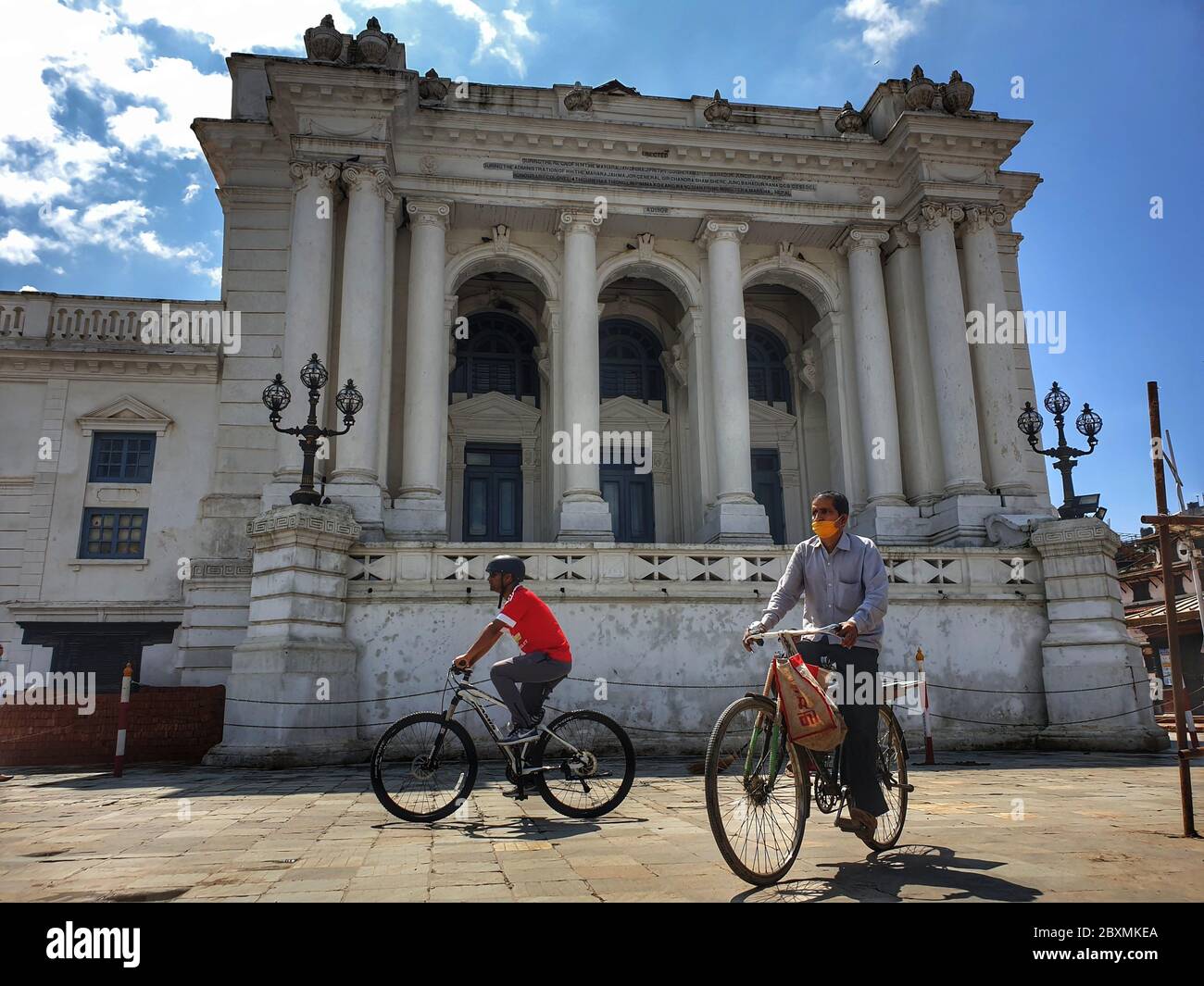 Kathmandu, Nepal. 8th June, 2020. People ride bicycle in front of Gaddi ...