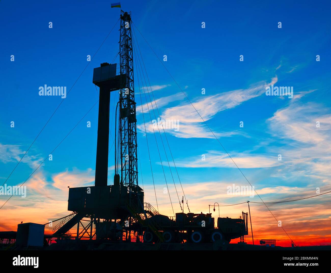 drilling rig on the background of a bright sunset Stock Photo - Alamy