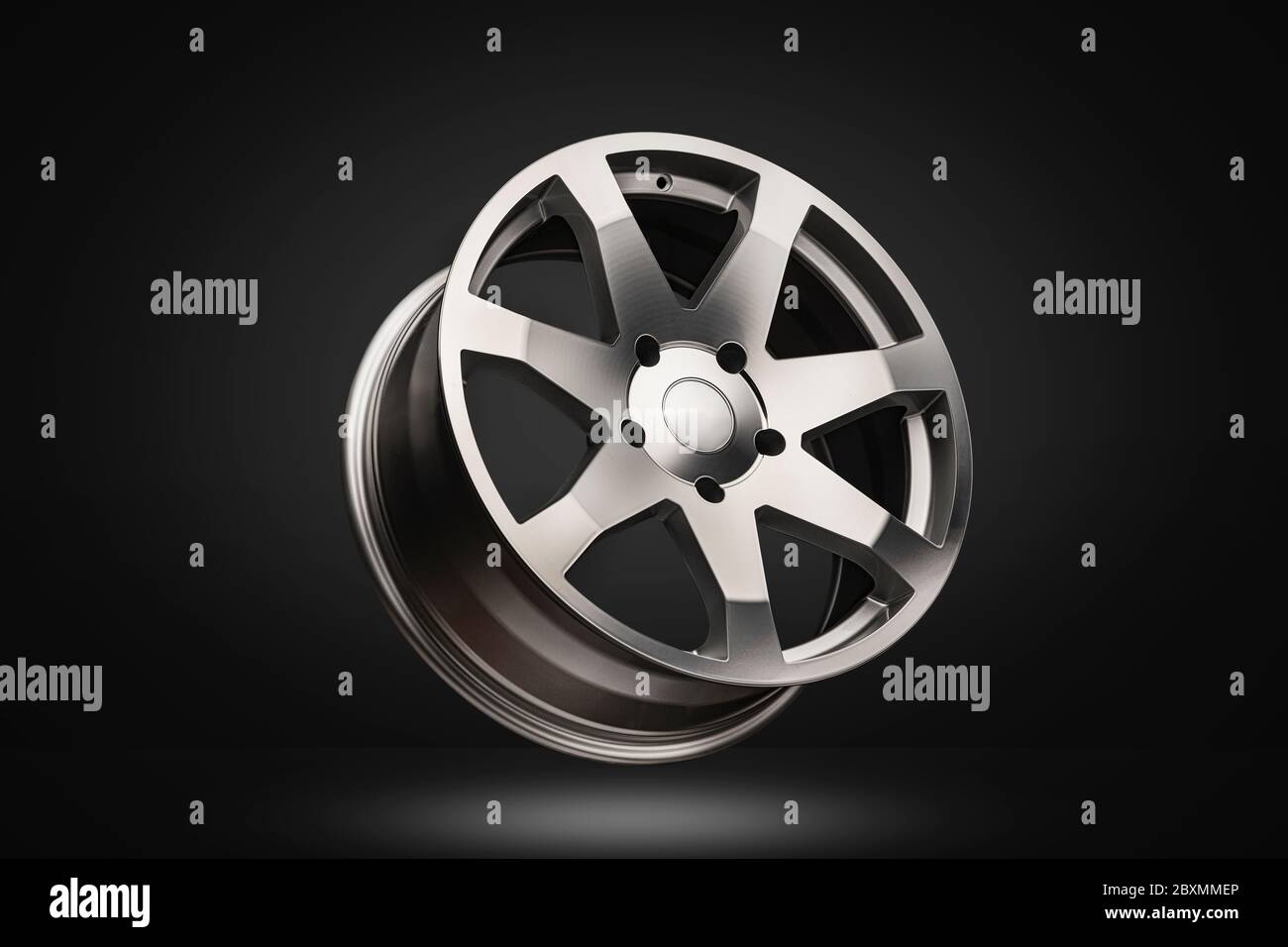 New polished silver alloy wheel on dark gradient background. modern ...