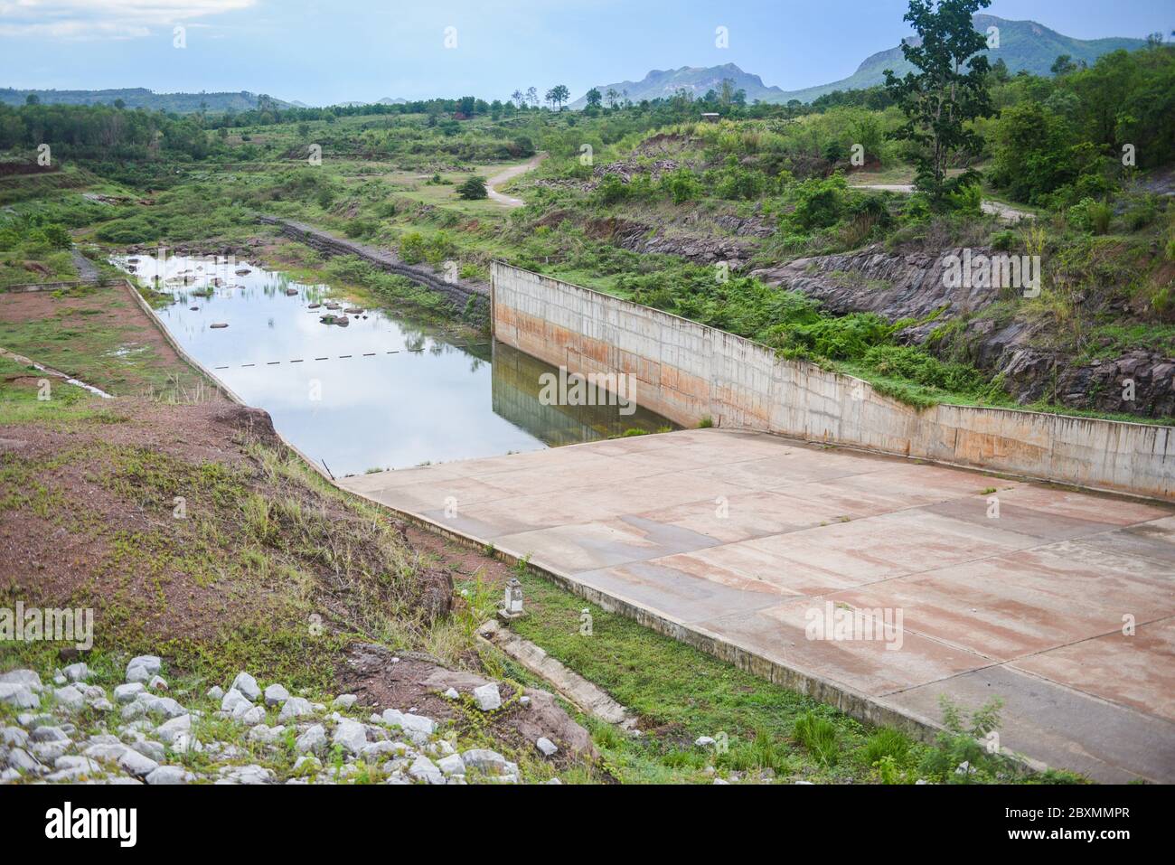 Drain canal behind the dam drains excess water from the lake / Drainage ...