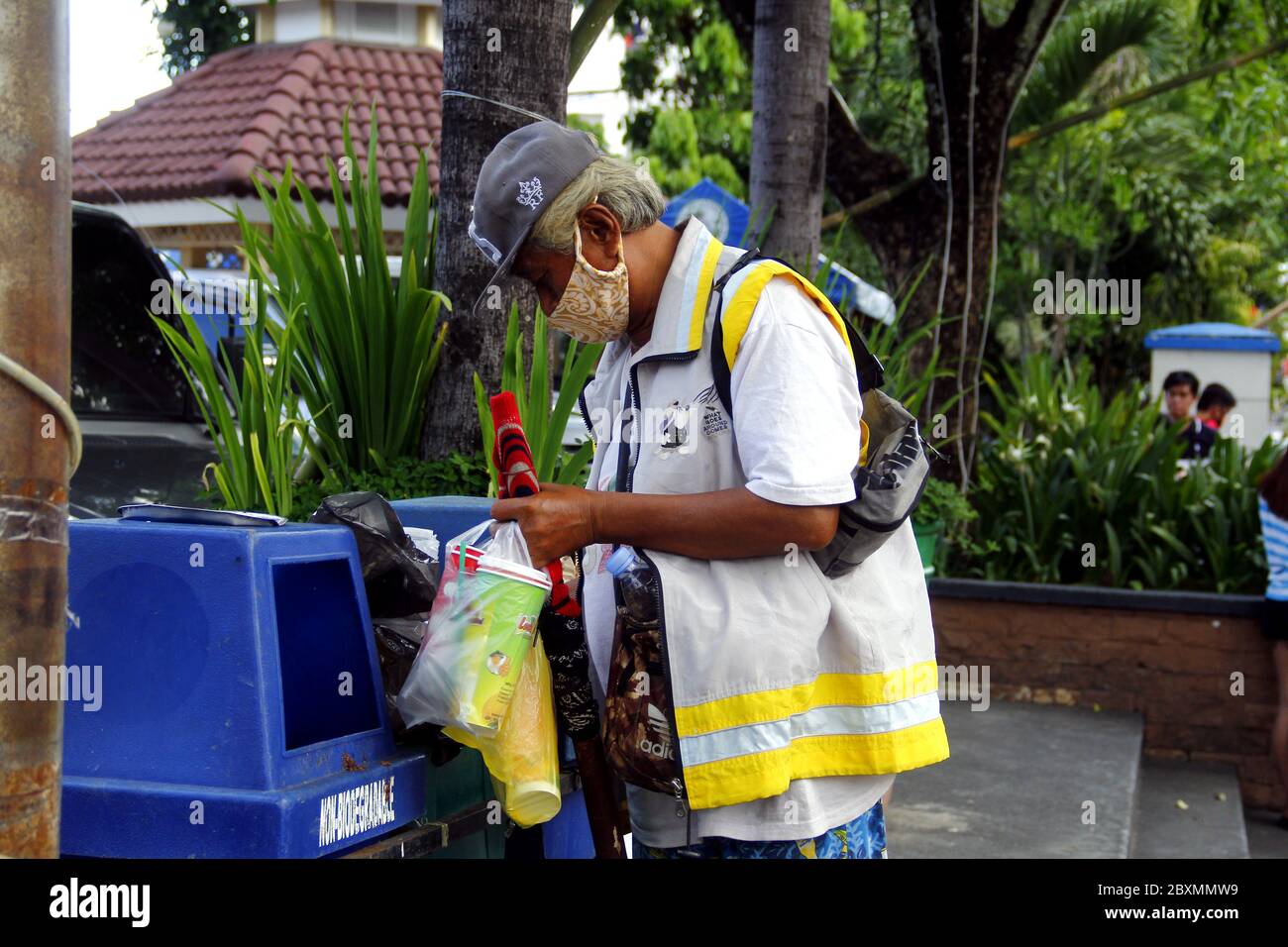 Antipolo City, Philippines - June 1, 2020: Scavenger go through a trash ...