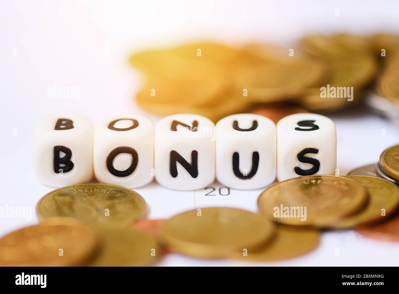 Yearly Bonus concept / words of Bonus and Stack coins on calendar ...