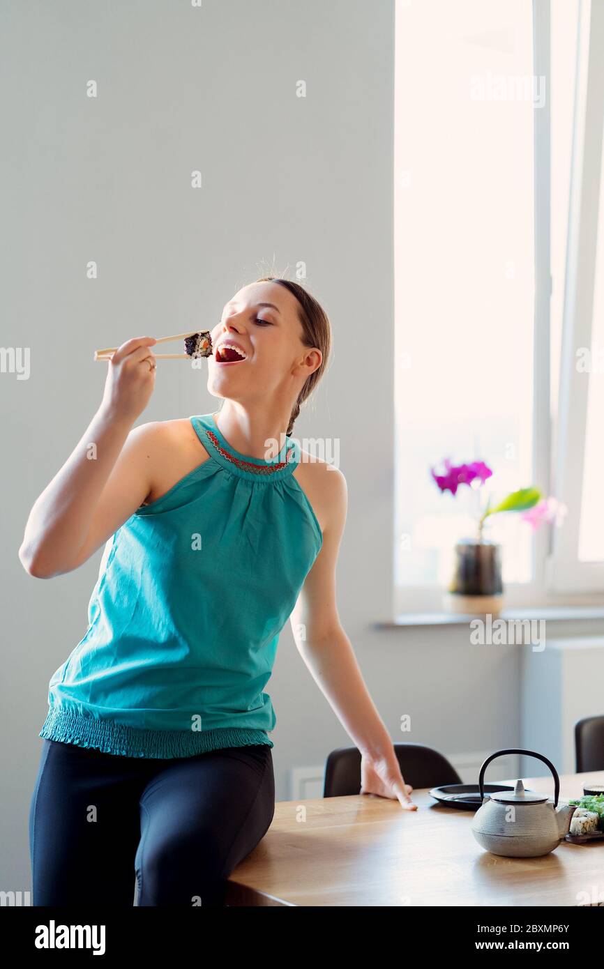 Pretty Woman Enjoying a meal with an expression of bliss as she ...