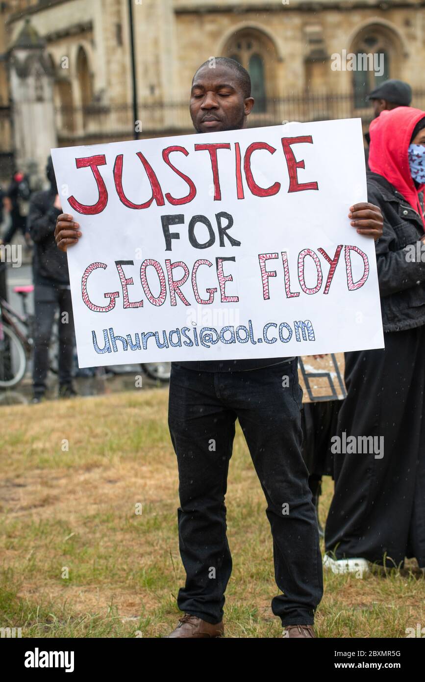 Man holding a JUSTICE FOR GEORGE FLOYD poster/sign at the London Black ...