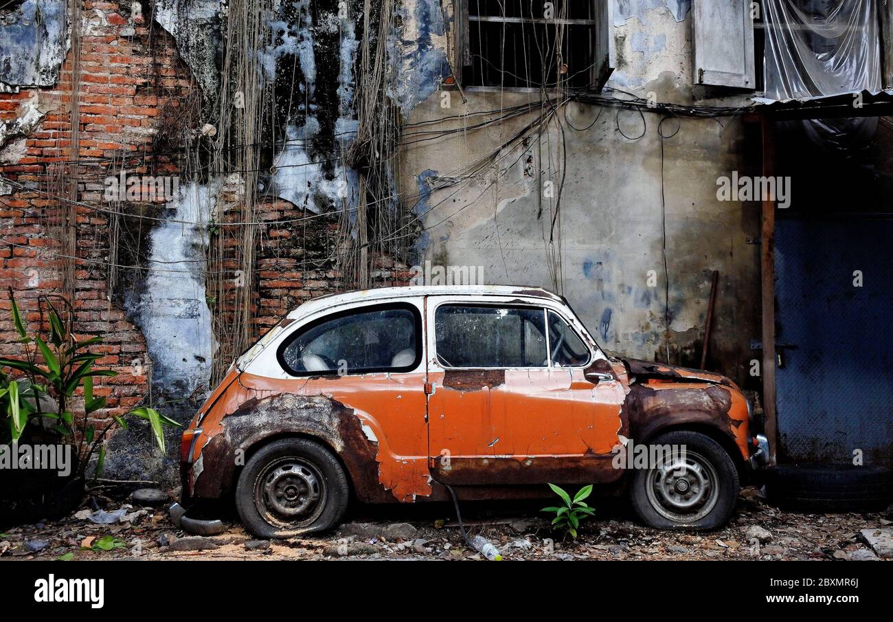 A rusty old Italian Fiat Bambino car pictured in an alley of Chinatown ...
