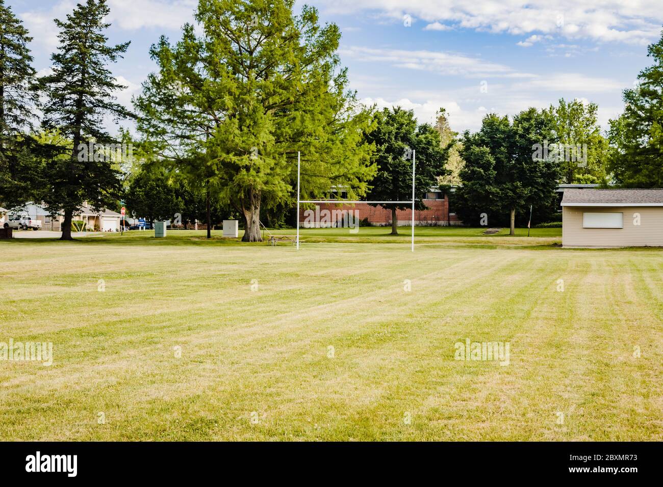 the view from the midfield of a youth football field in a city park ...