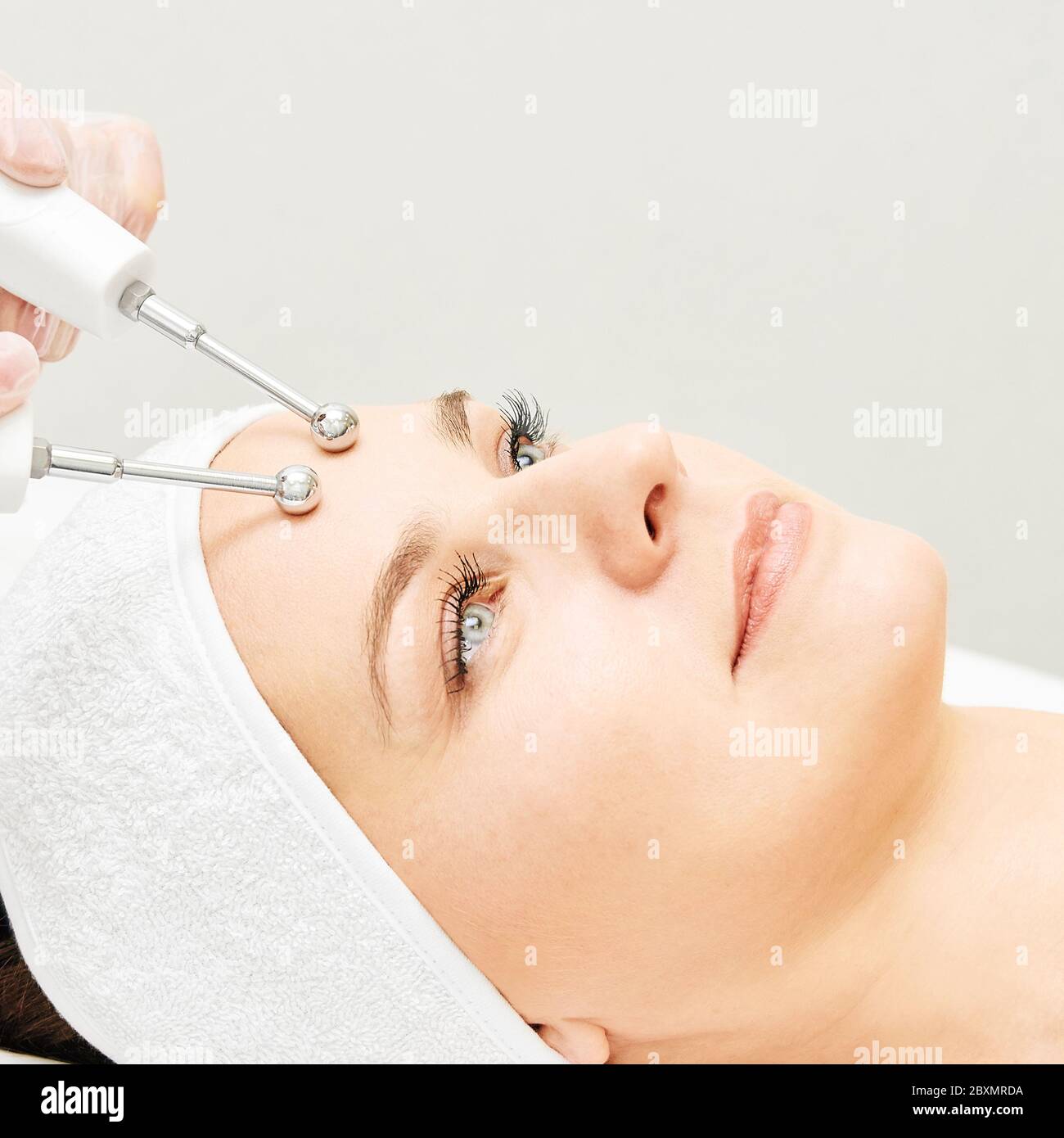 Microcurrent esthetics procedure. Beauty girl face. Cosmetology machine ...