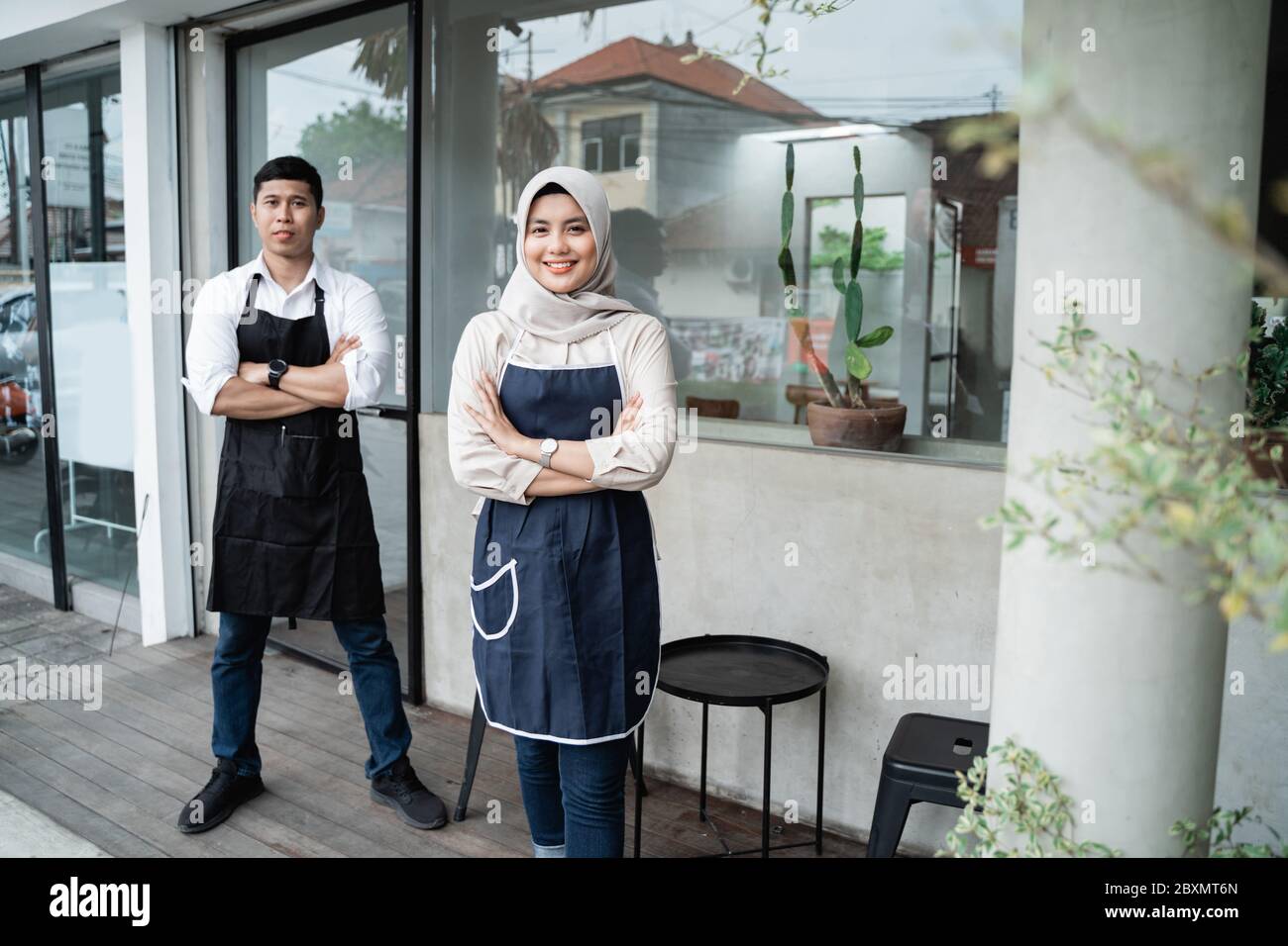 two waitress standing with crossed hands pose in preparation for ...