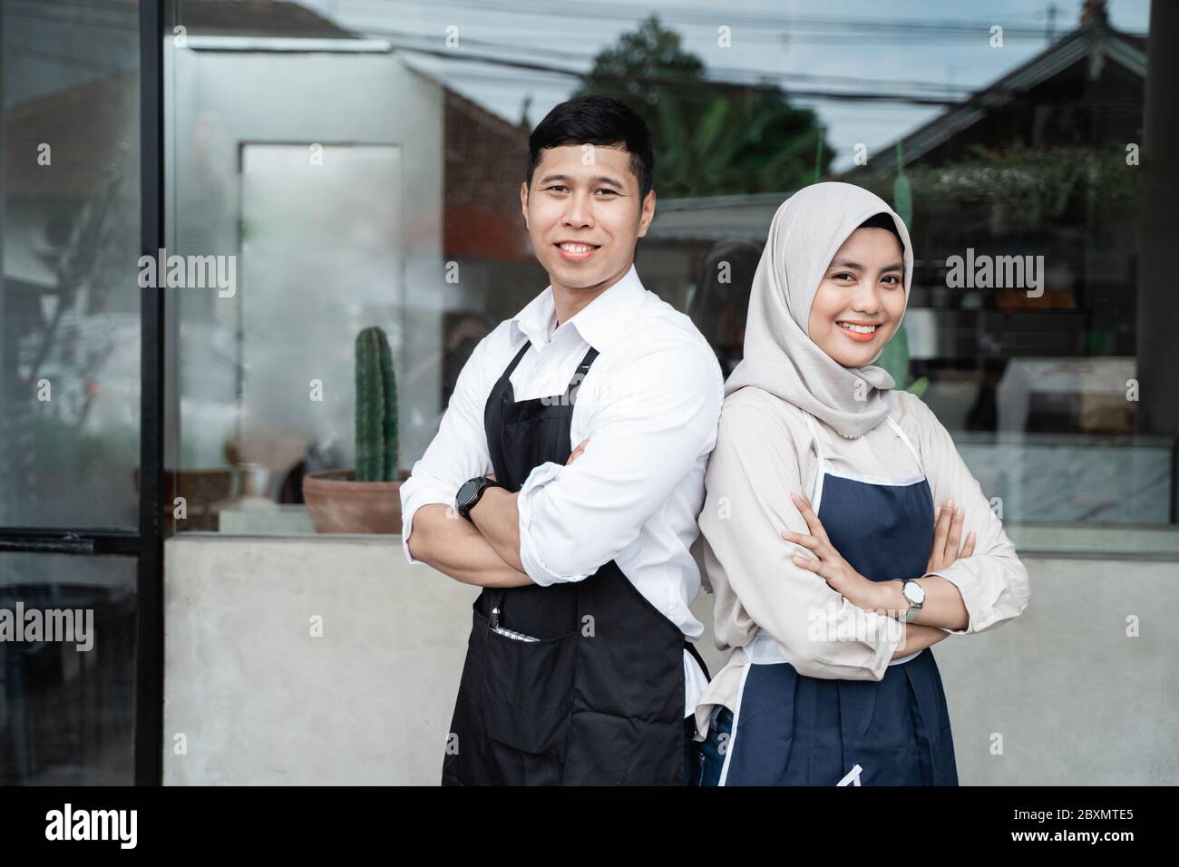 two waitress standing with crossed hands pose in preparation for ...