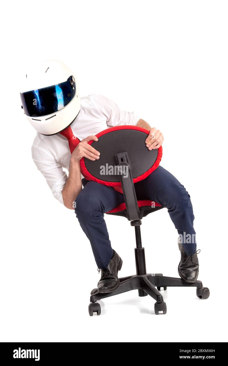 Businessman racing in an office chair with helmet, isolated in white ...