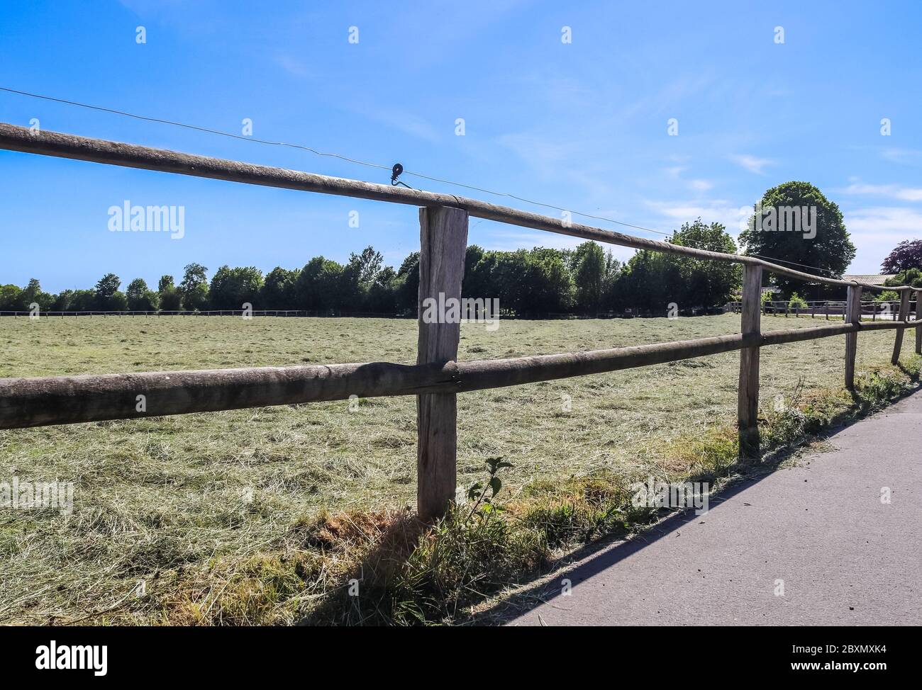 Beautiful wooden horse fence at an agricultural field on a sunny day ...