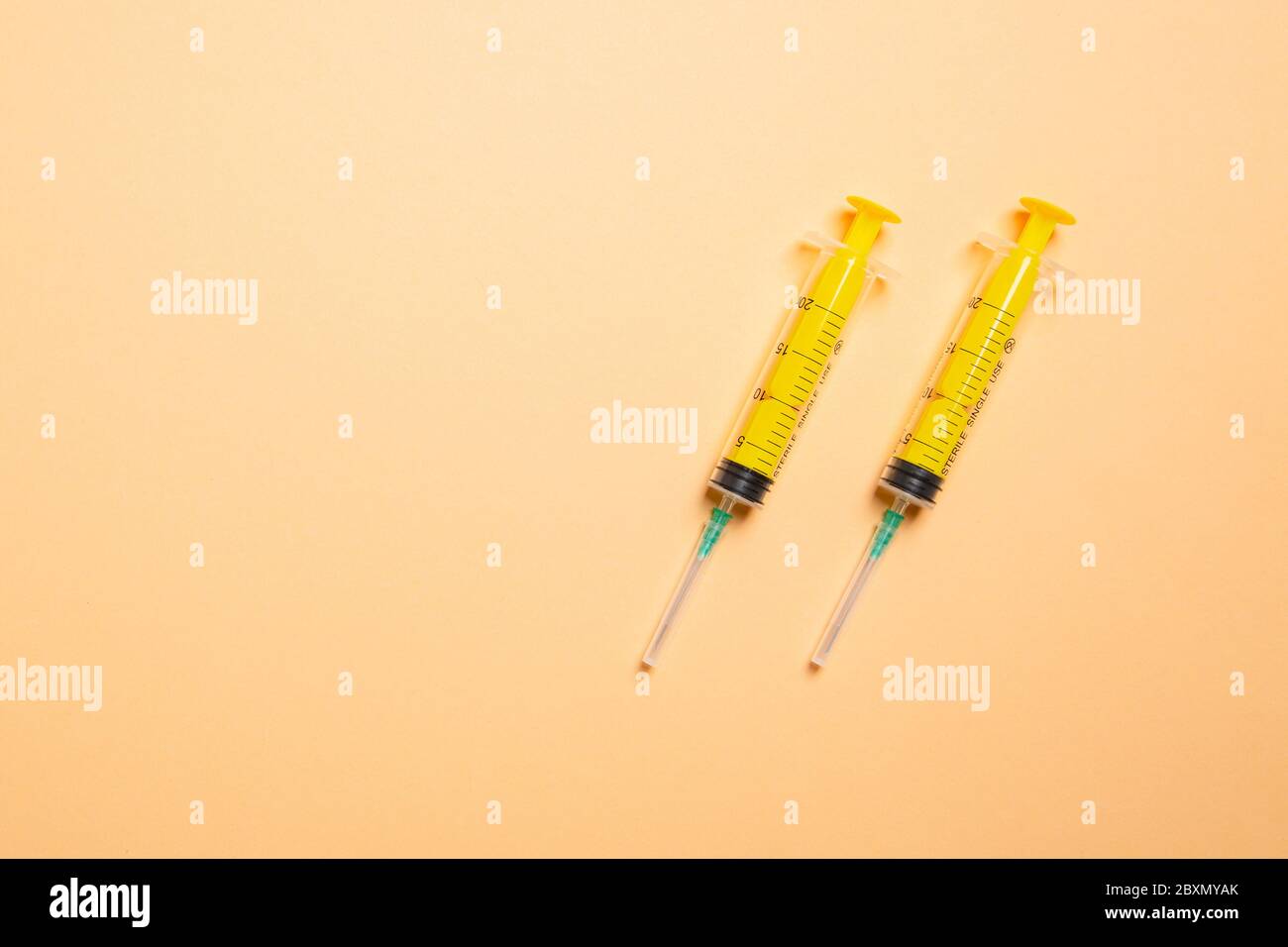 Top view of different syringes for injection on colorful background ...