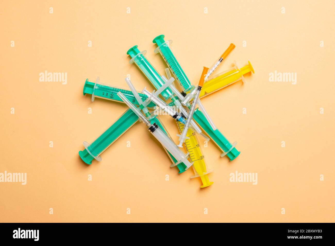 Top View Of A Heap Of Syringes And Insulin Syringes At Orange Background Medical Injection